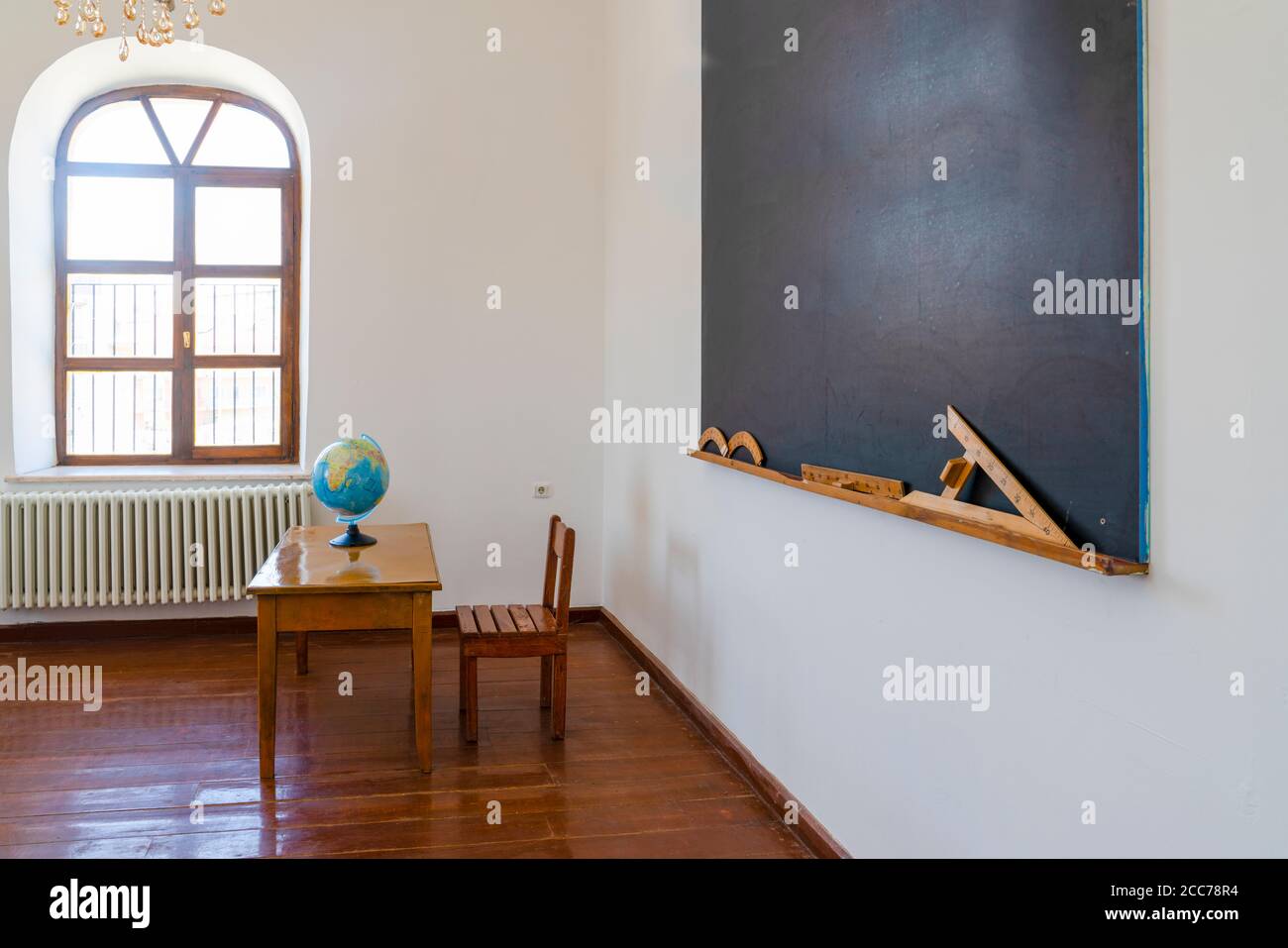 For the geography lesson, the globe stands on the teacher's desk. Tools ...