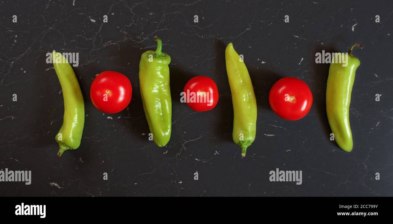 Top down view - tomatoes and sweet white pointed peppers arranged in ...
