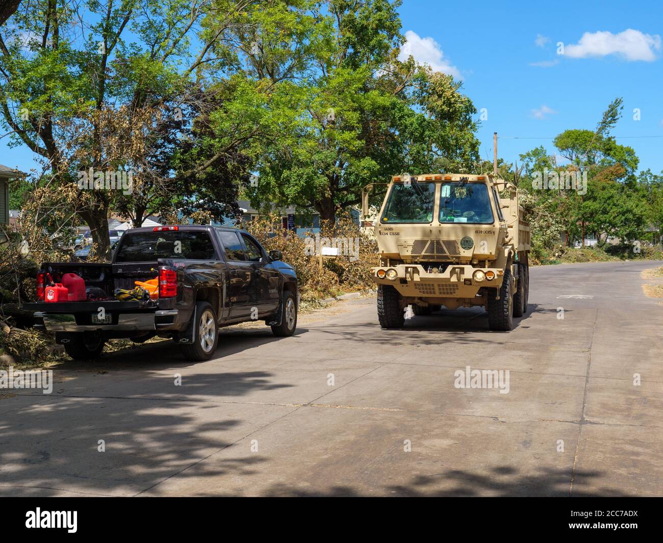 An Iowa National Guard truck hauls debris from derecho of August 10 ...