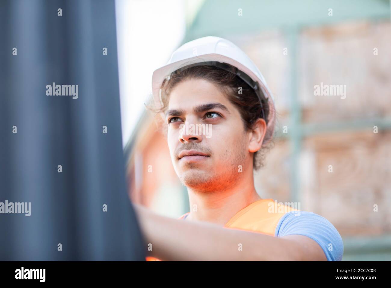 young store worker with helmet working in a store Stock Photo - Alamy