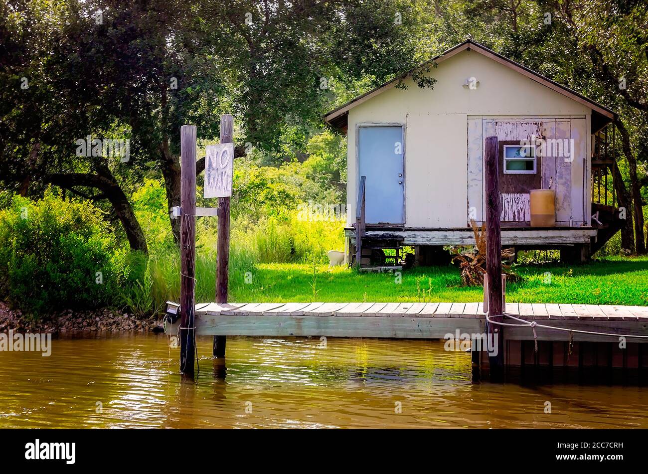 A “no wake” sign encourages boaters to travel slowly past one of the ...