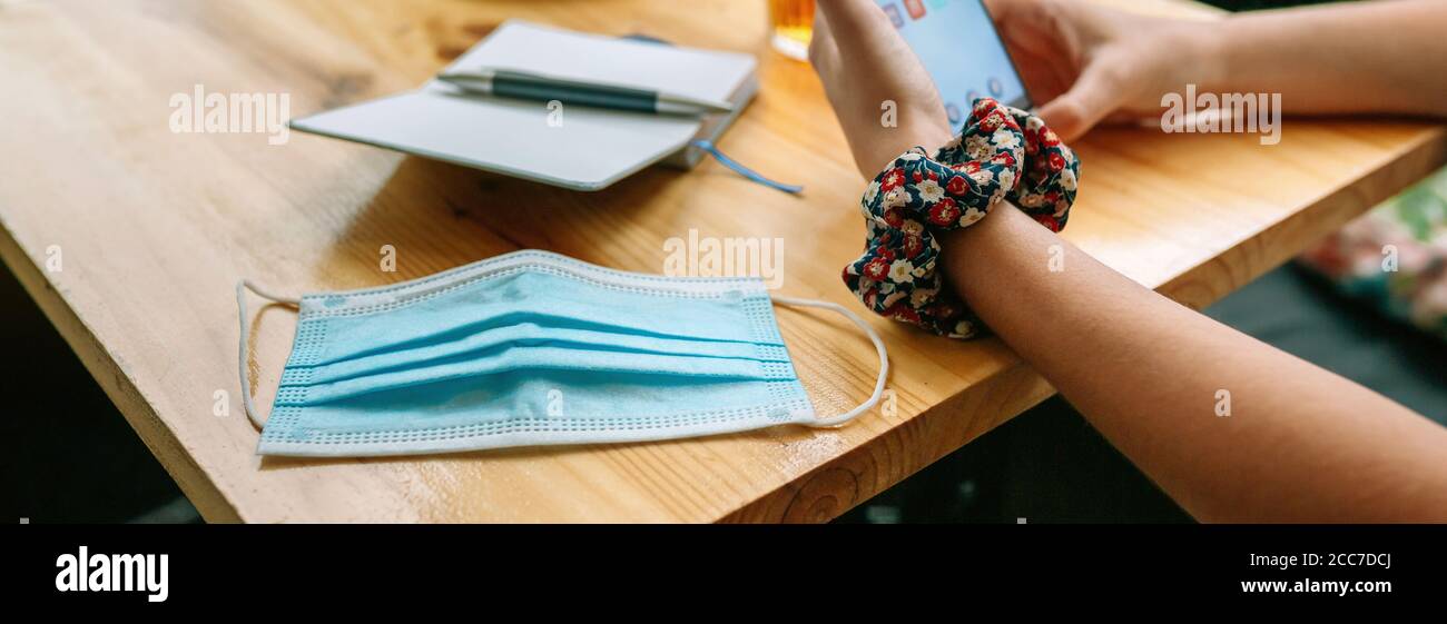 Face mask leaning on coffee shop table Stock Photo - Alamy
