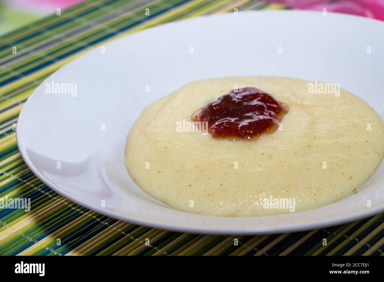 Semolina with jam on a green bamboo background Stock Photo - Alamy
