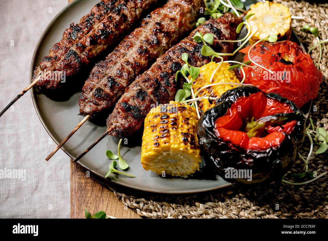 Eastern fast food. Grilled spicy beef lyulya kebab on sticks on flat ...