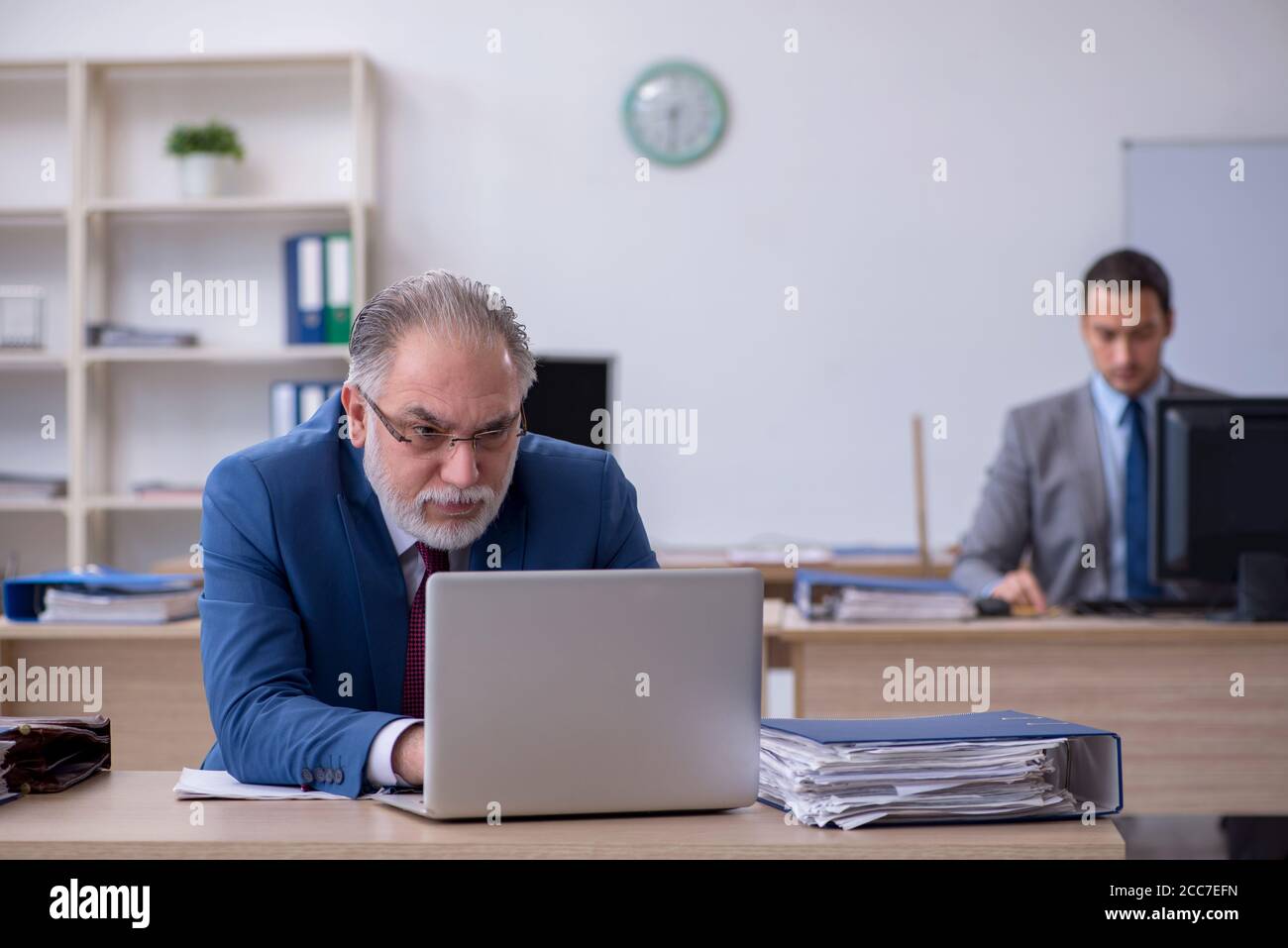 Two employees working in the office Stock Photo - Alamy