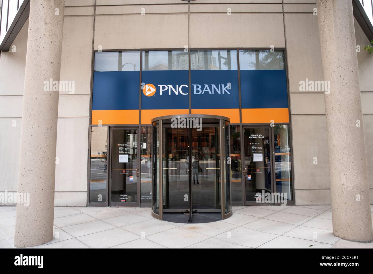 A PNC Bank sign hangs outside a bank branch in downtown Milwaukee ...