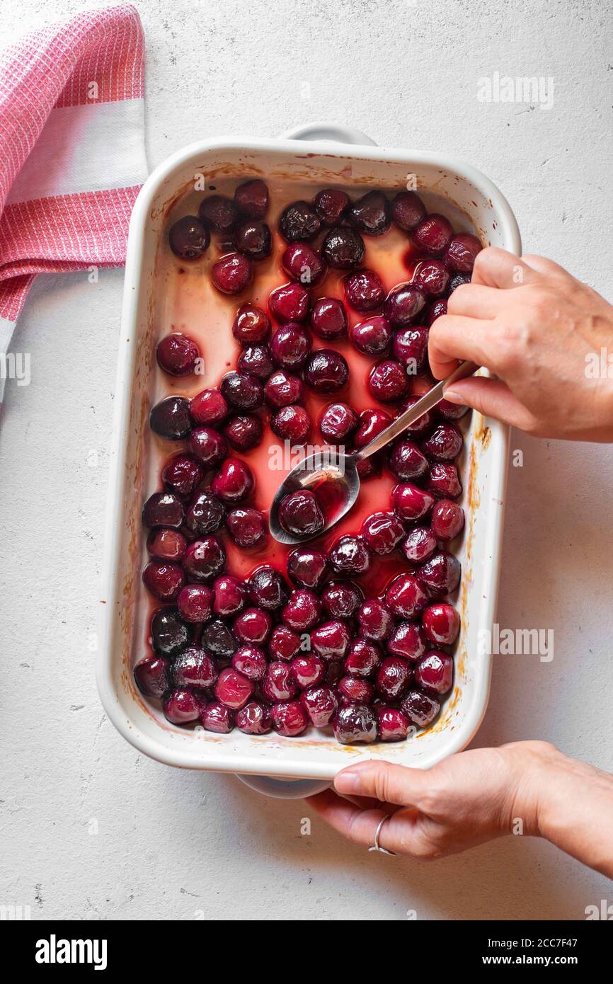 Roasted cherries in a pan Stock Photo - Alamy