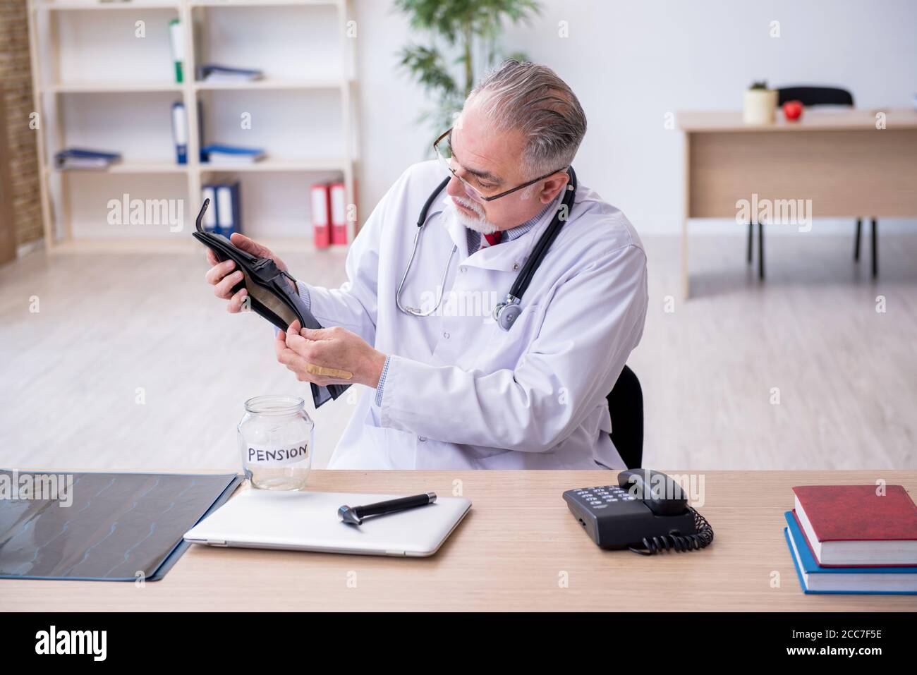 Old doctor in retirement concept Stock Photo - Alamy