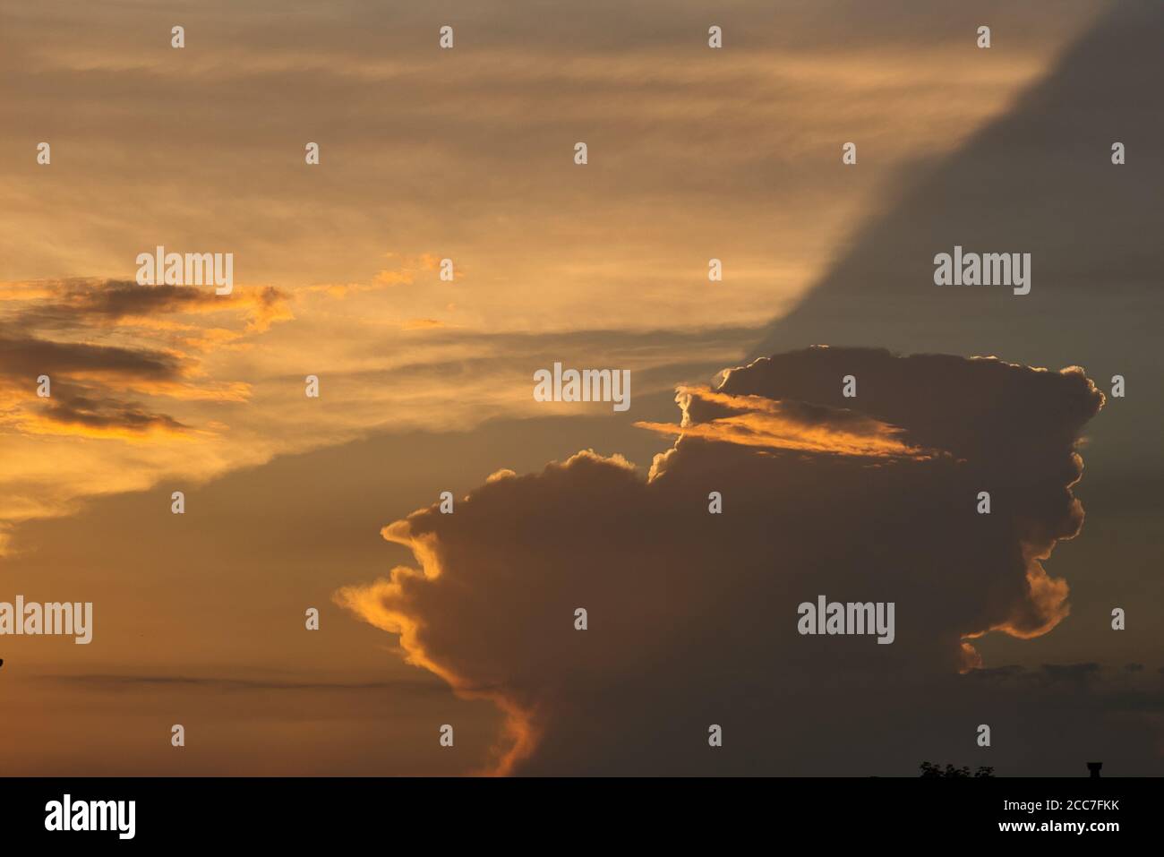 Clouds formation in the evening sky with sun light behind Stock Photo ...