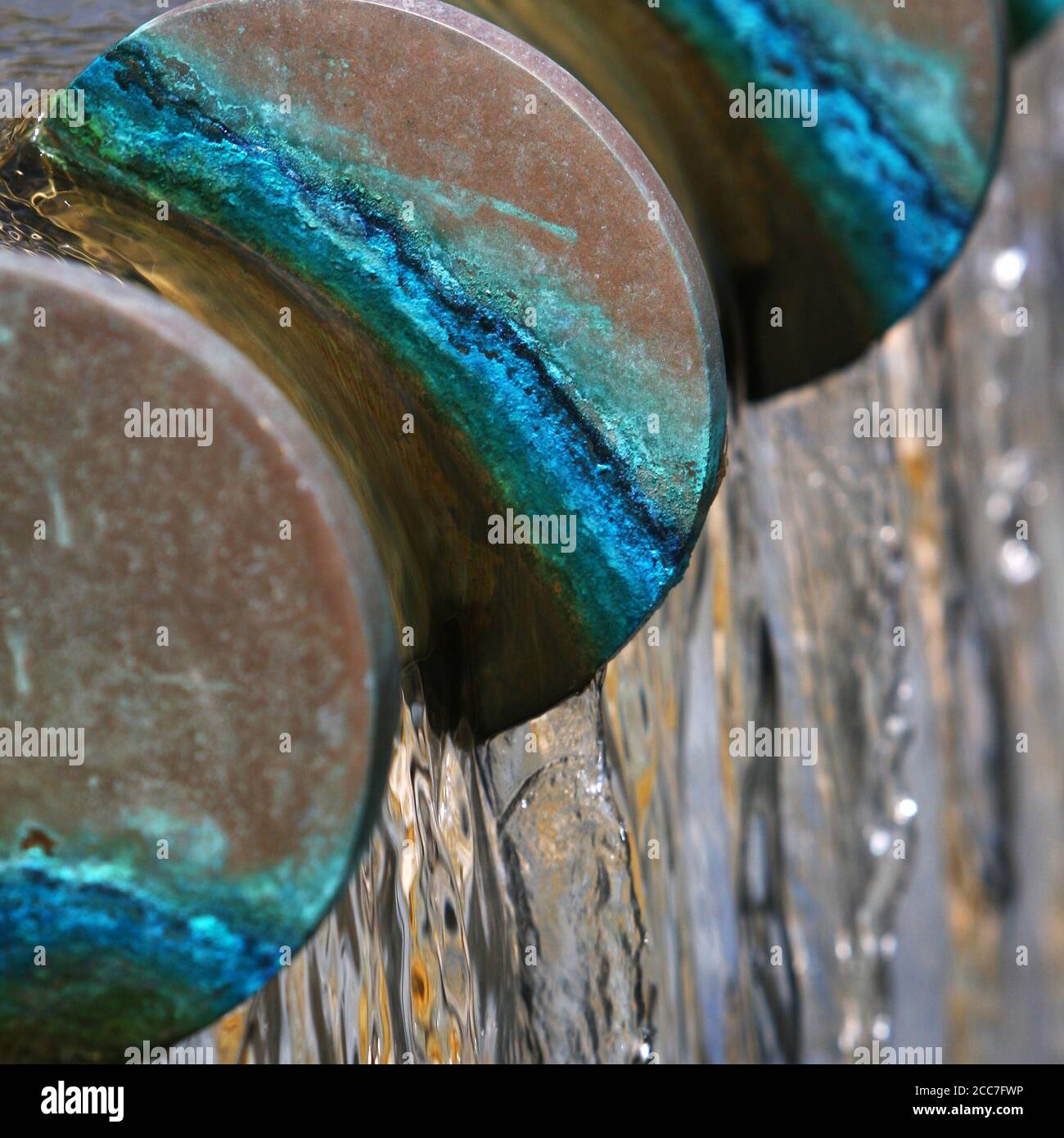 Bronze discs on a water fountain that developed a colorful patina Stock ...