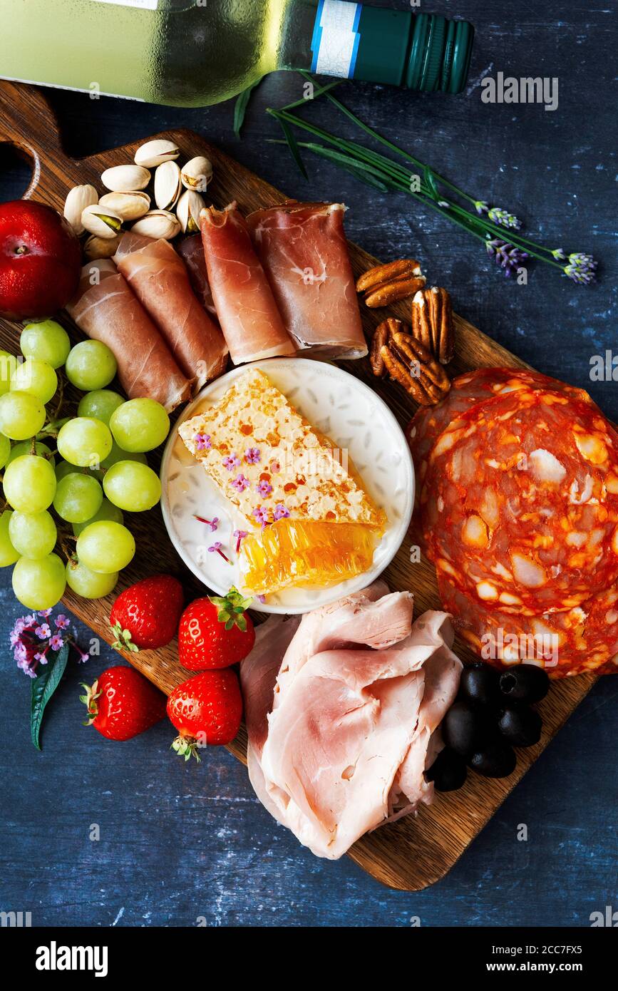 Meat platter with honey comb, chorizo, roast beef, prosciutto, grapes ...