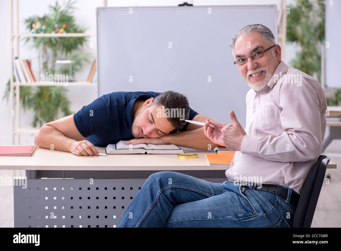 Old teacher and young student in the classroom Stock Photo - Alamy