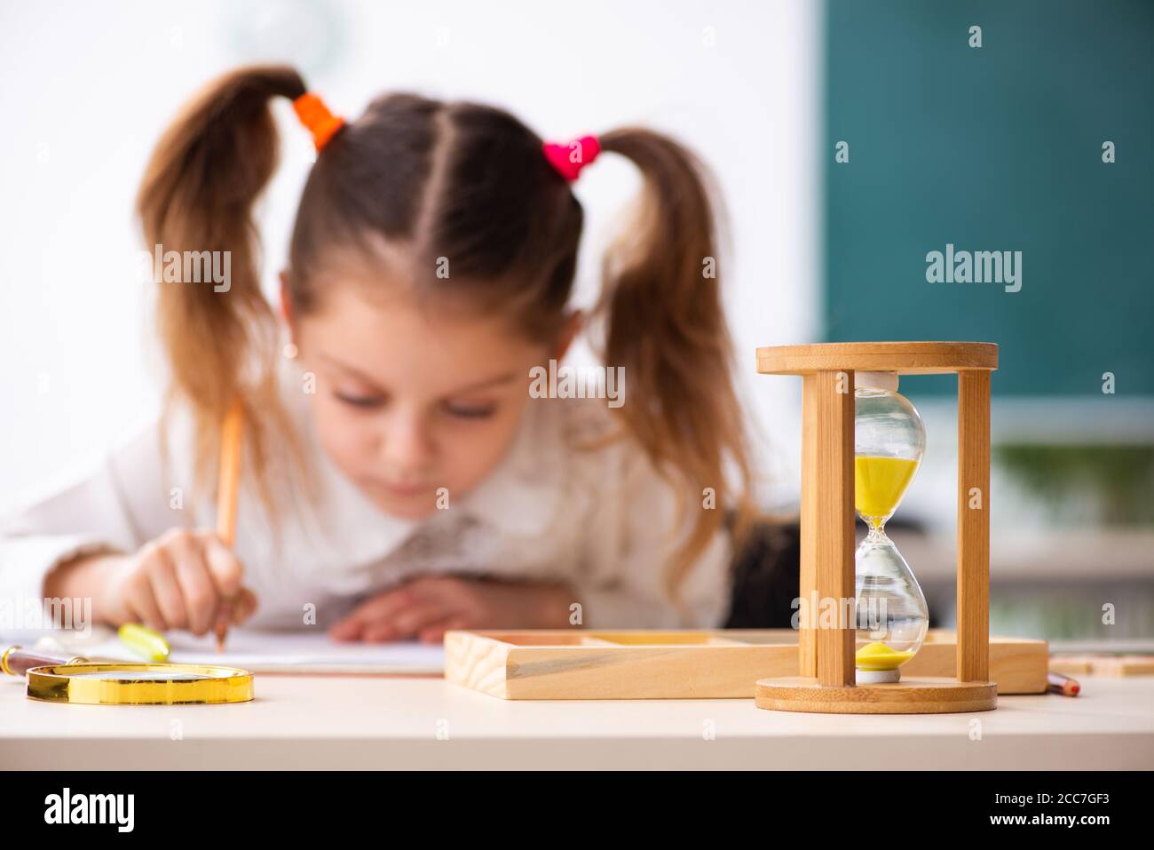 Small girl in the time management concept Stock Photo - Alamy