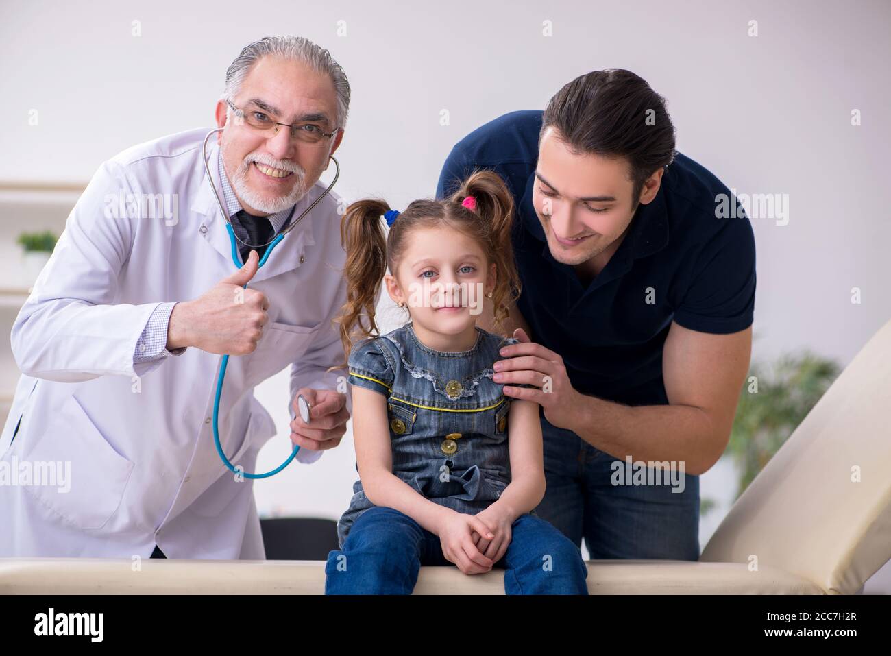Young father and his daughter visiting old doctor Stock Photo - Alamy