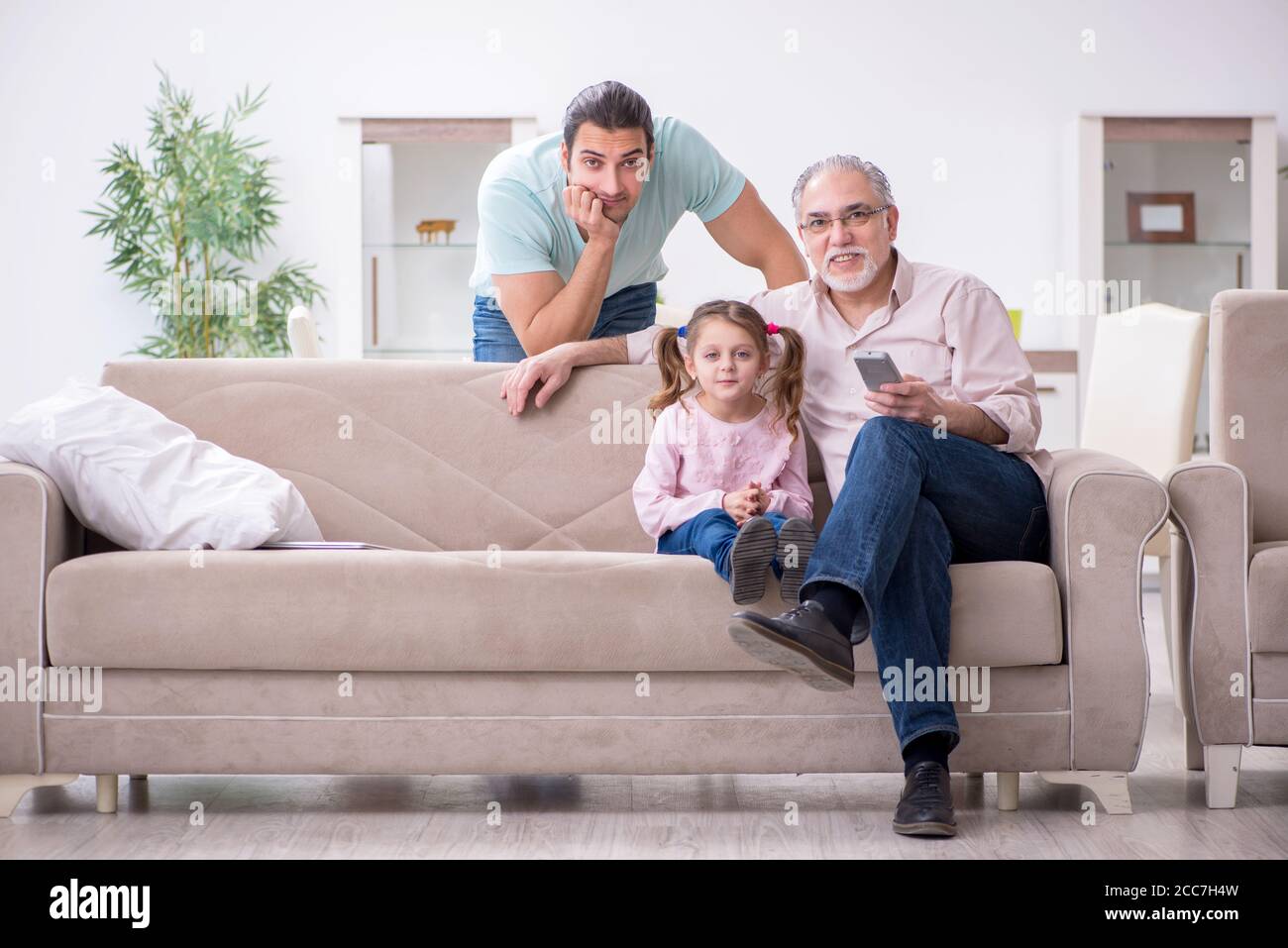 Three generations family watching tv hi-res stock photography and ...