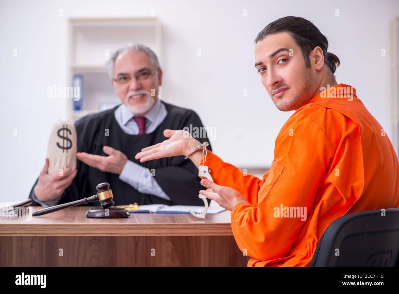 Old judge meeting with young captive in courthouse Stock Photo - Alamy