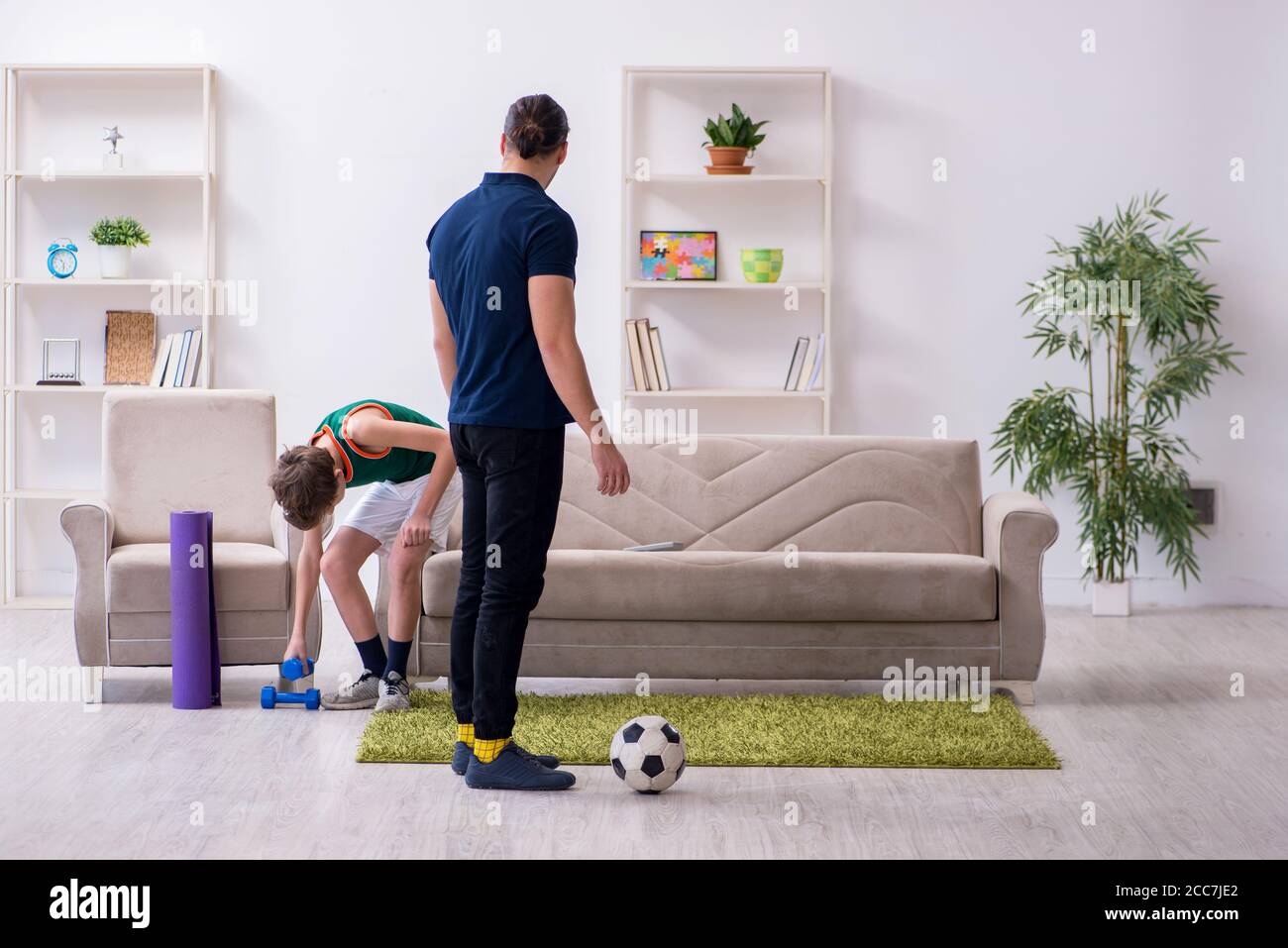 Father and son doing sport exercises at home Stock Photo - Alamy