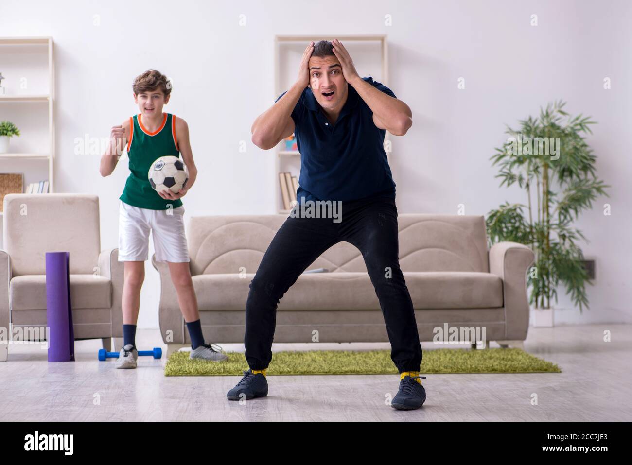 Father and son doing sport exercises at home Stock Photo - Alamy