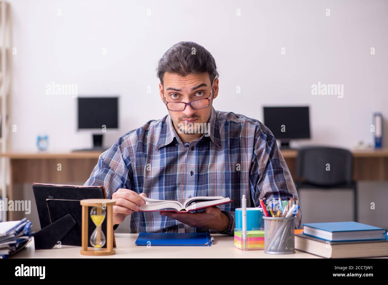 Young student sitting in the classroom Stock Photo - Alamy