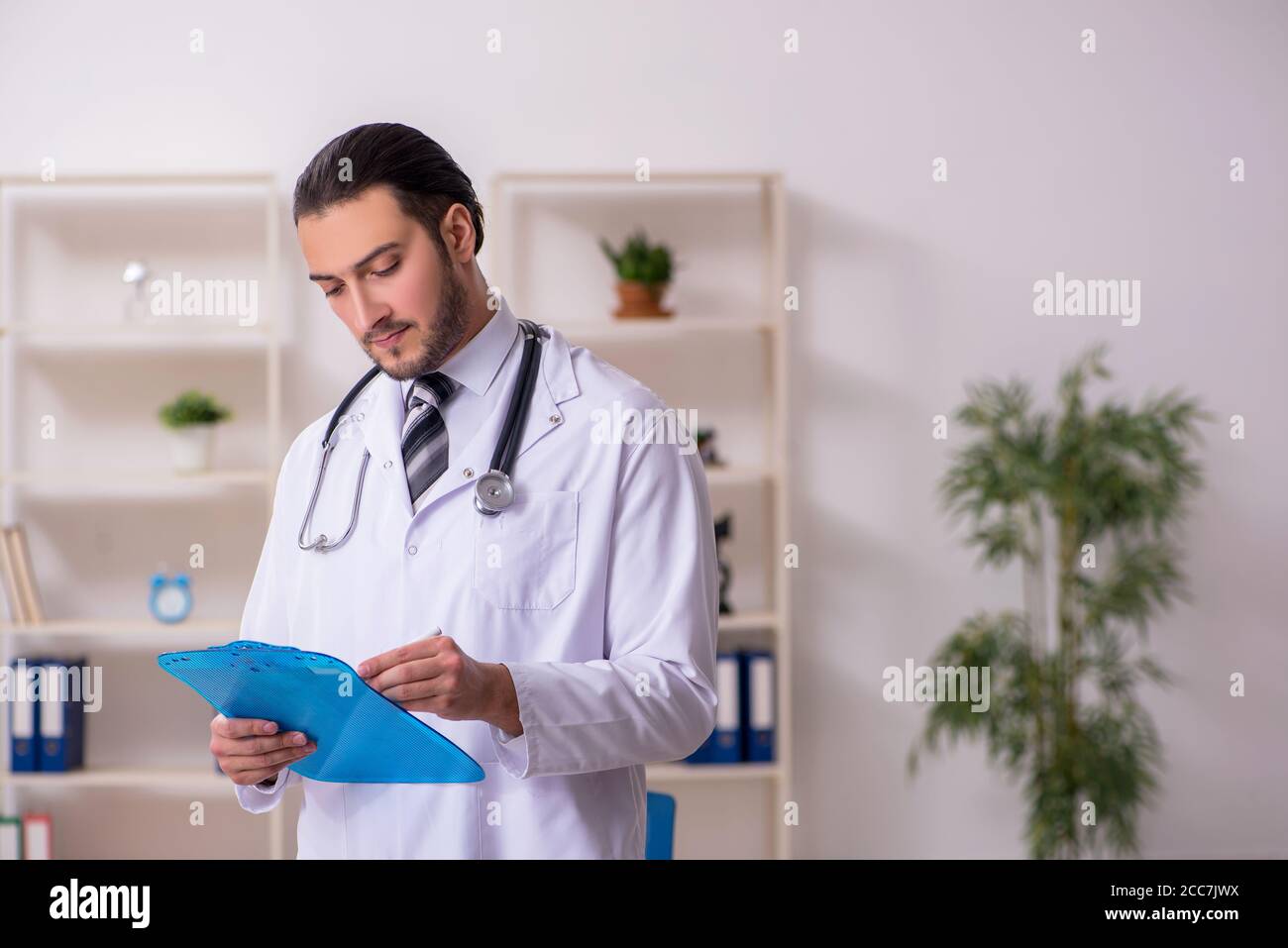 Young male doctor working in the clinic hospital Stock Photo - Alamy