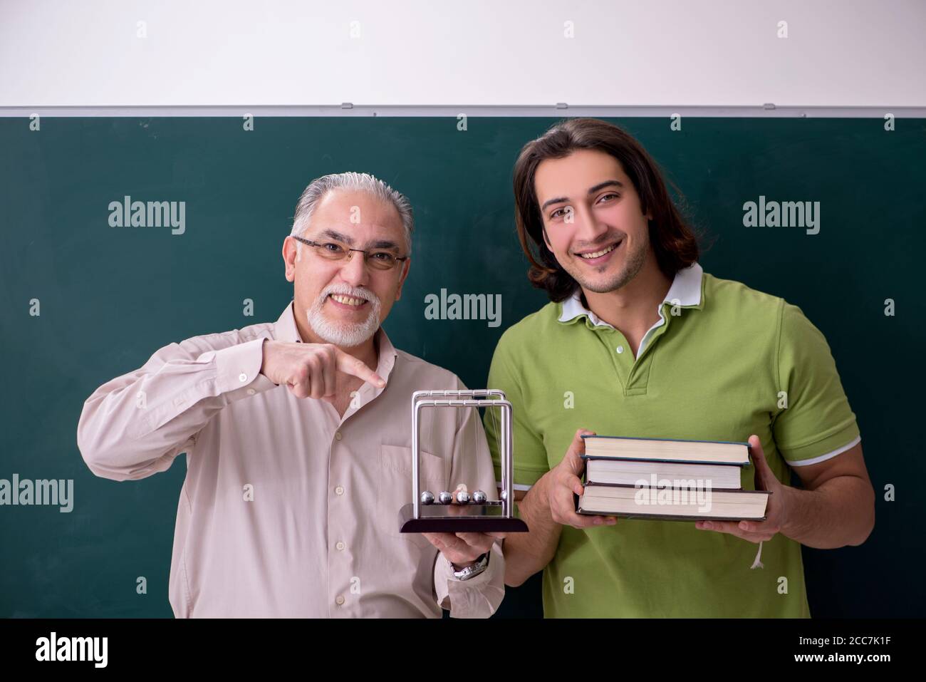 Old professor physicist and student in the classroom Stock Photo - Alamy