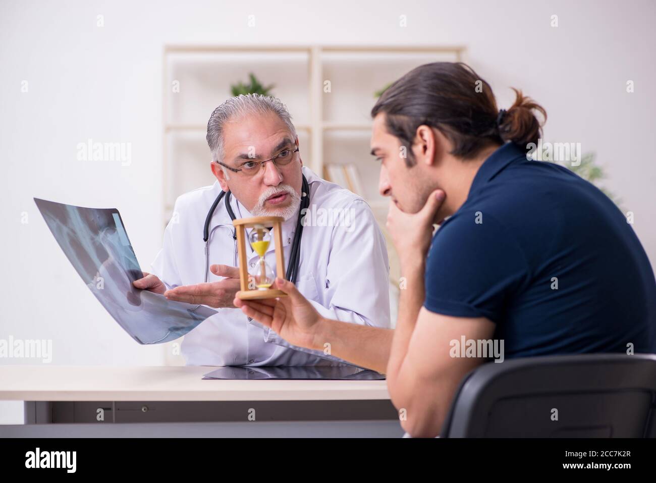 Male patient visiting doctor radiologist in time management concept ...