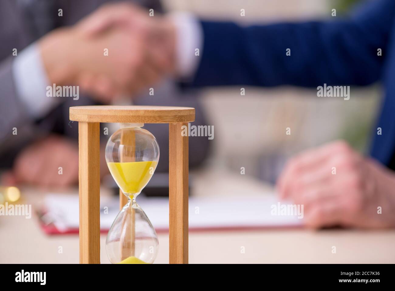 Two businessmen in the time management concept Stock Photo - Alamy