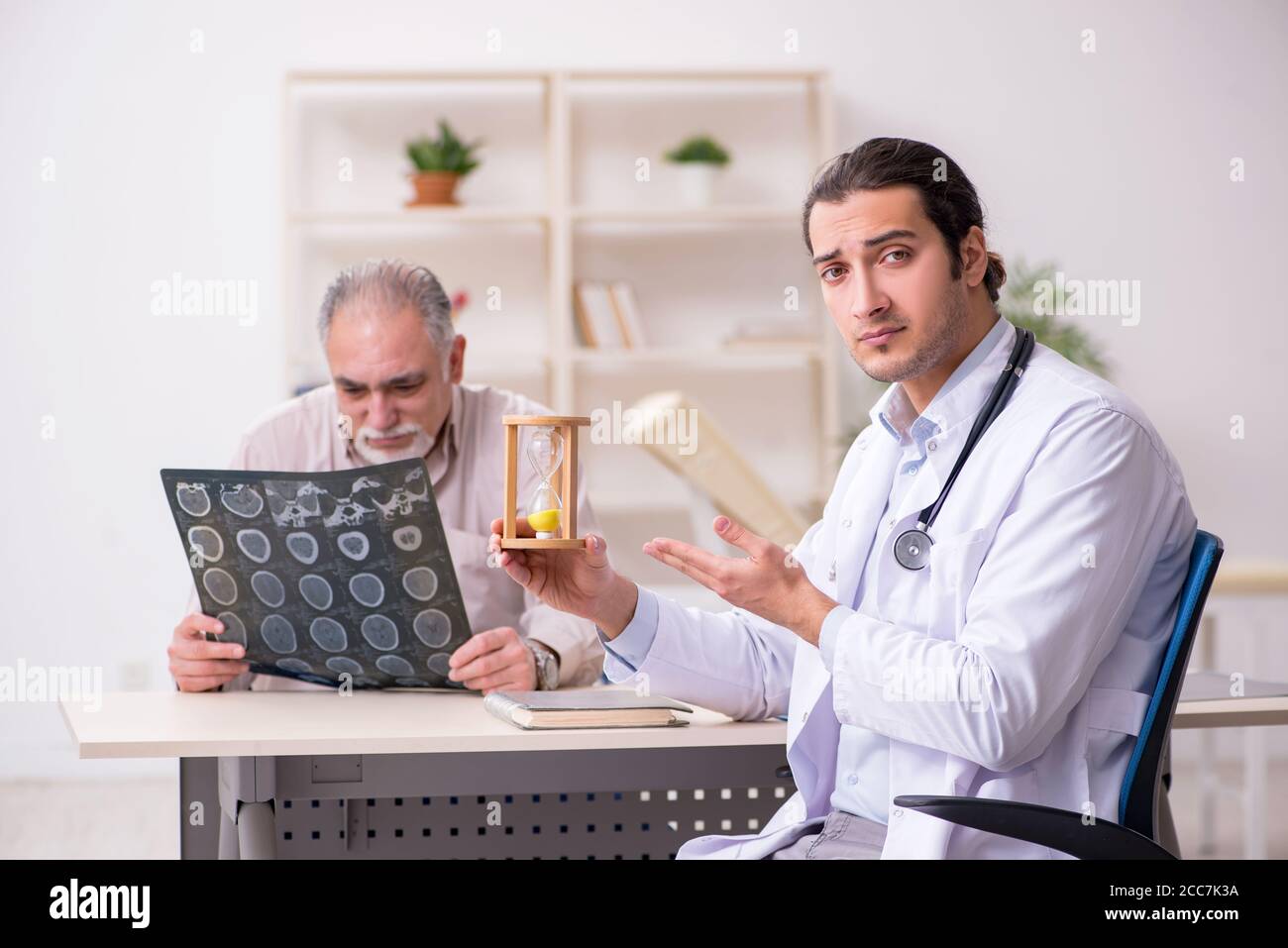 Male patient visiting doctor radiologist in time management concept ...