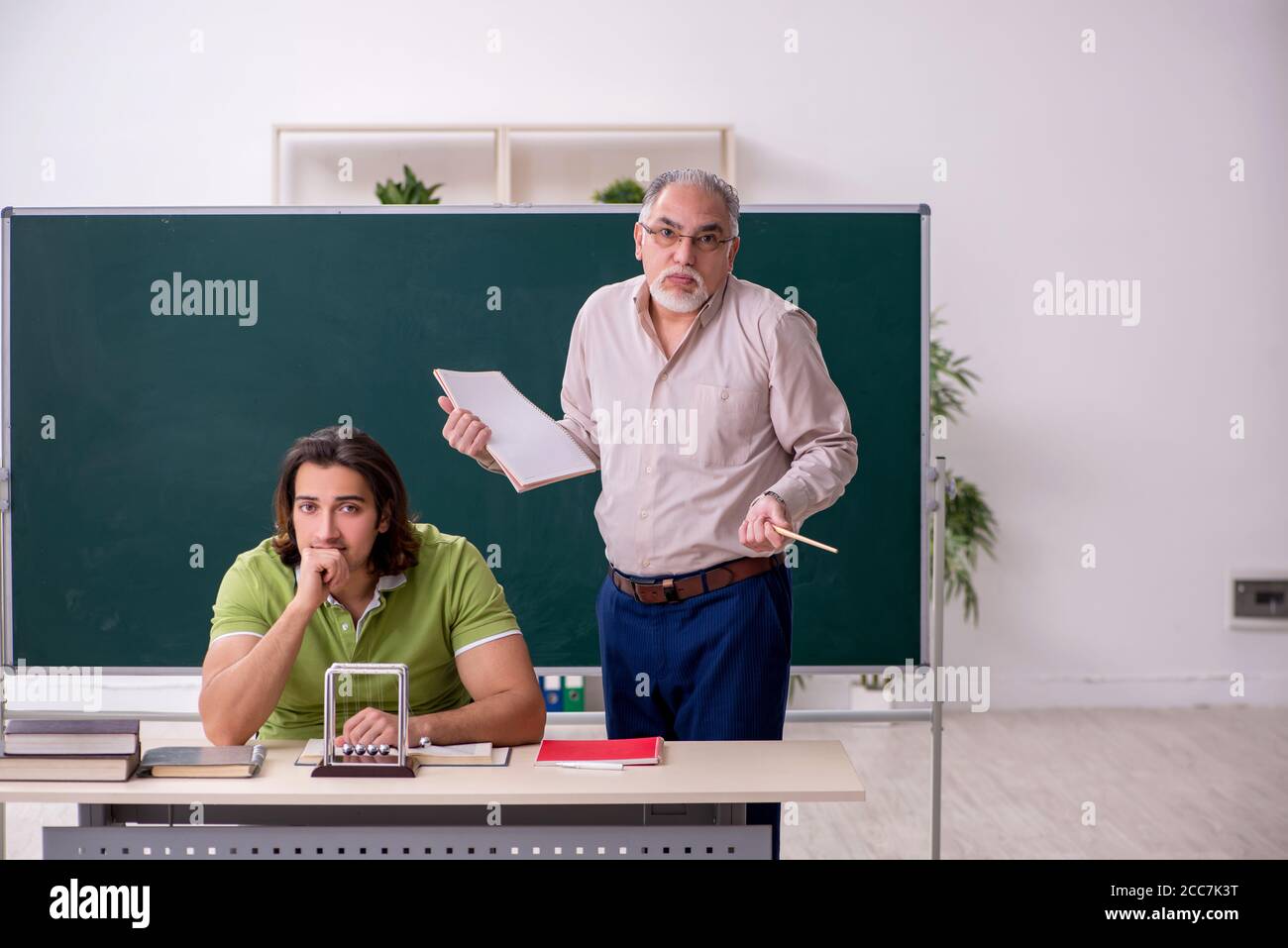 Old professor physicist and student in the classroom Stock Photo - Alamy