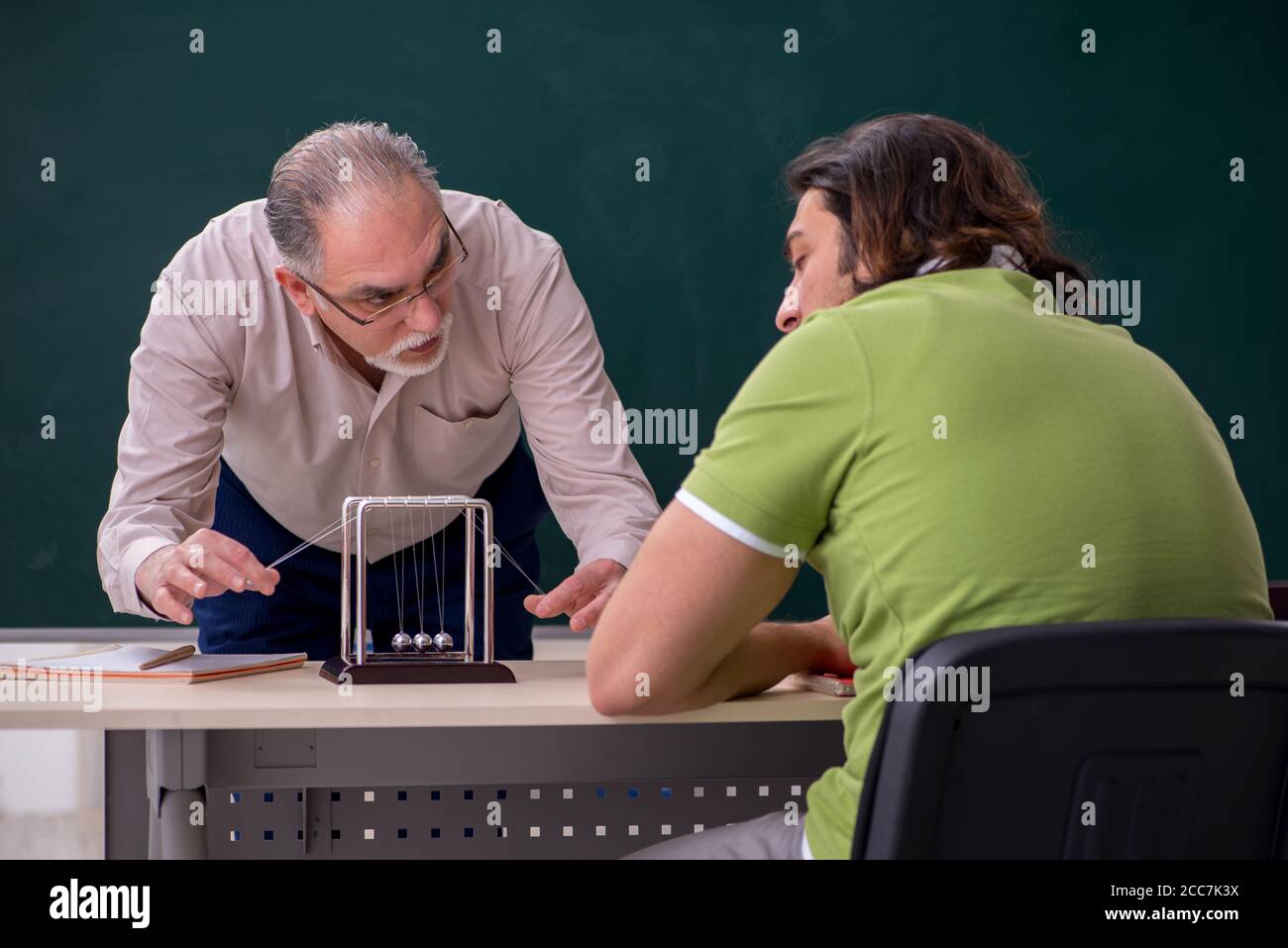 Old professor physicist and student in the classroom Stock Photo - Alamy