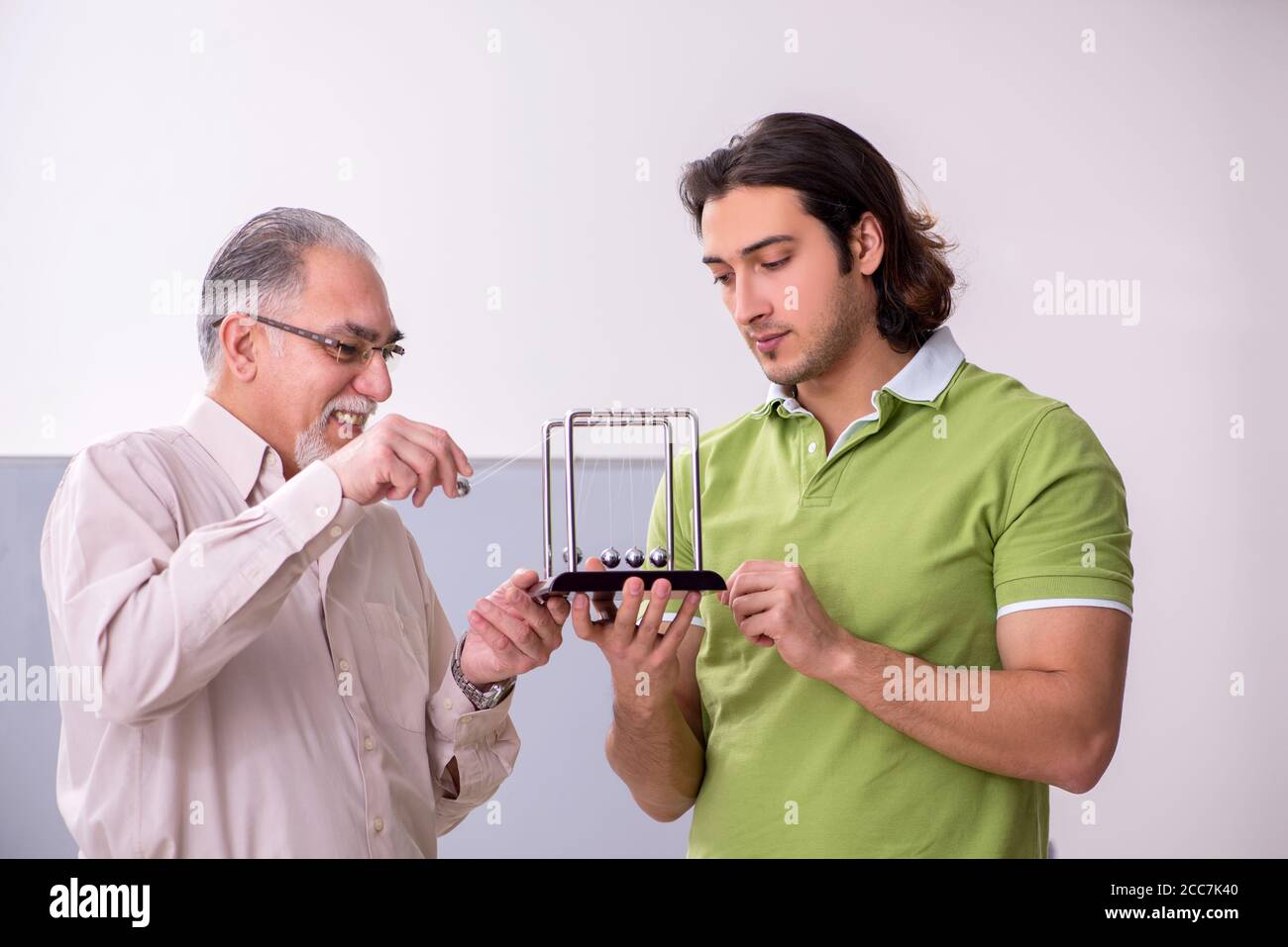 Old professor physicist and student in the classroom Stock Photo - Alamy