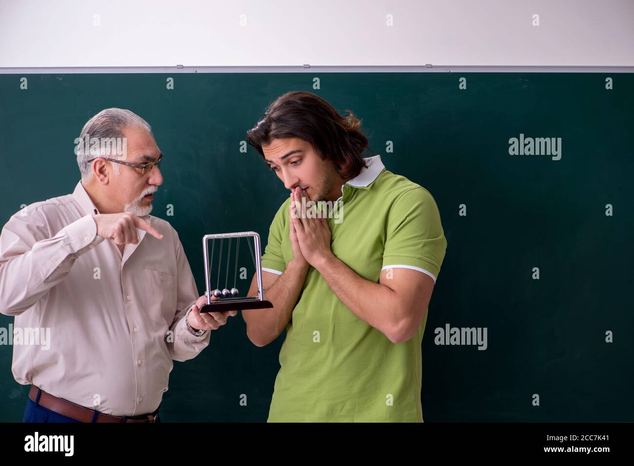 Old professor physicist and student in the classroom Stock Photo - Alamy