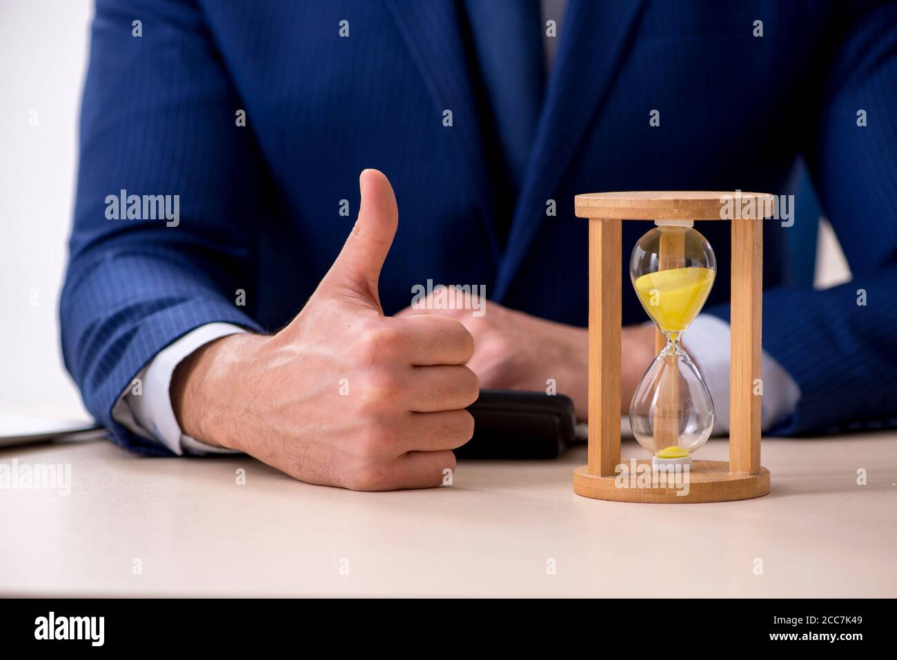 Young employee in time management concept Stock Photo - Alamy