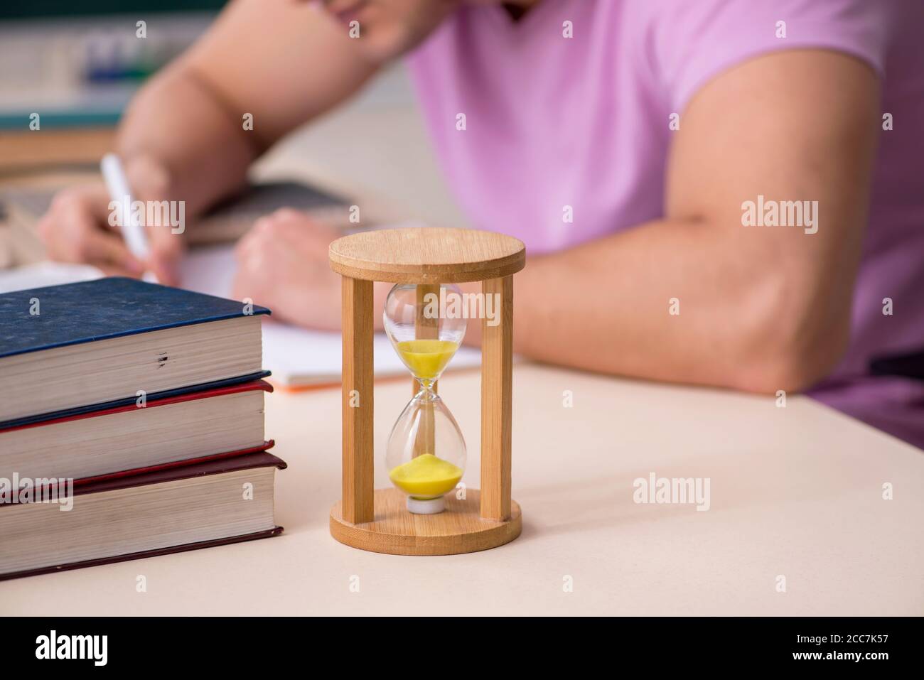 Young student in the classroom at time management concept Stock Photo ...