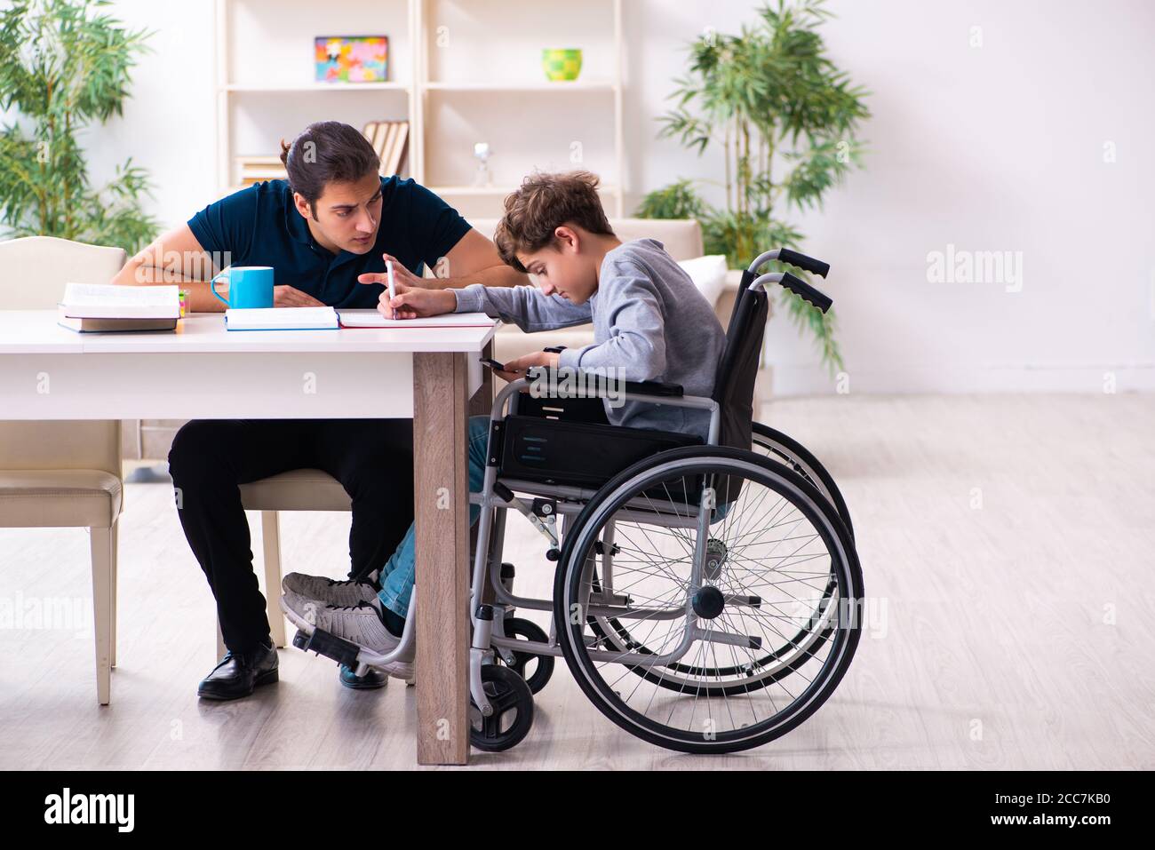 Father and disabled son in the education concept Stock Photo - Alamy