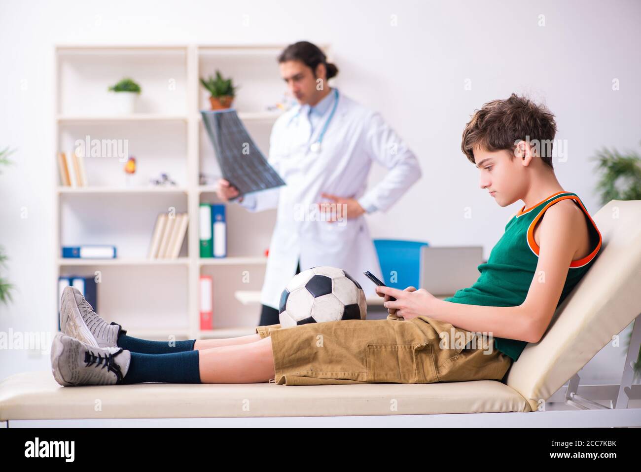 Sick boy visiting young doctor pediatrician Stock Photo - Alamy