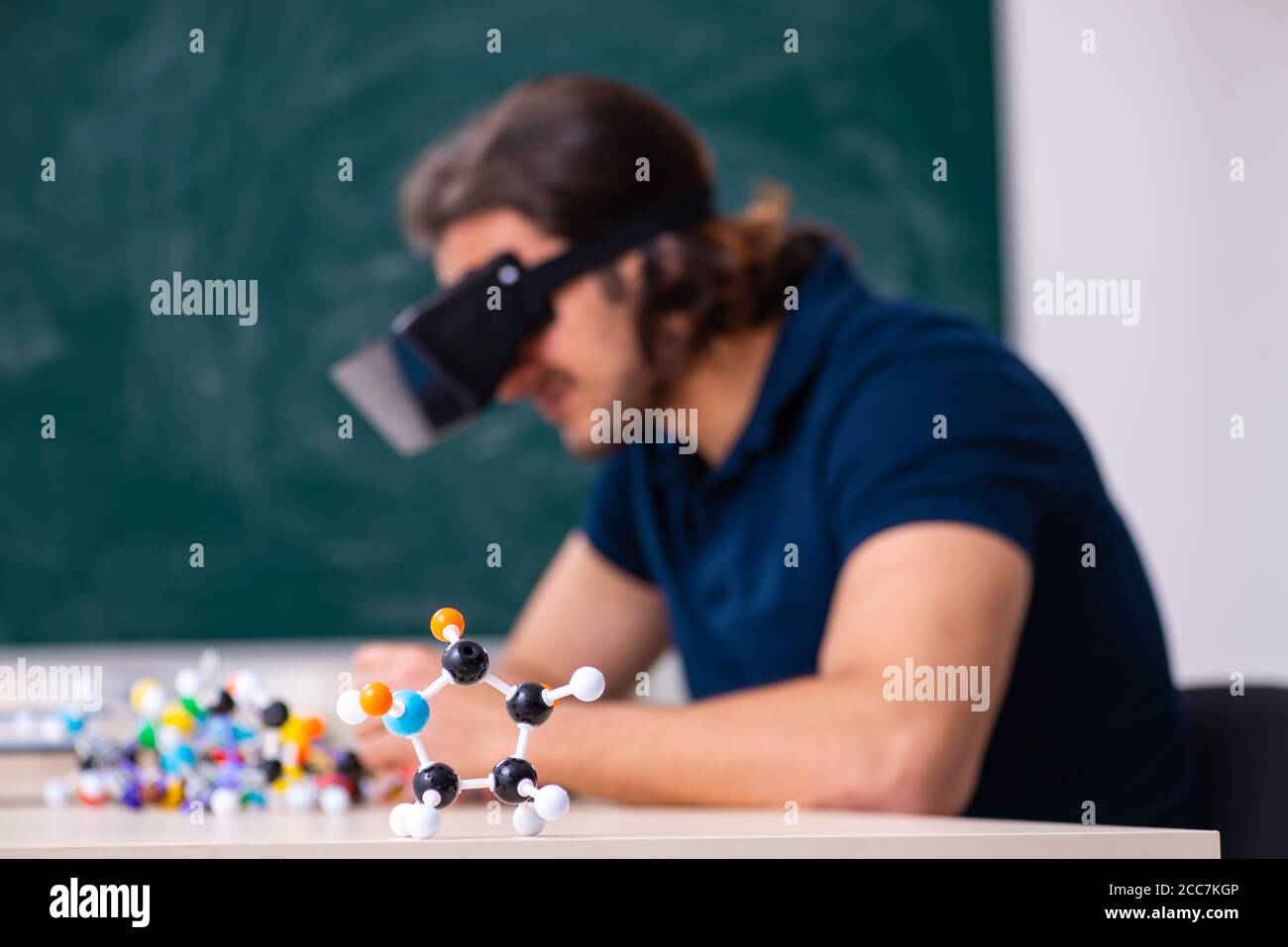 Young scientist sitting in the classroom Stock Photo - Alamy