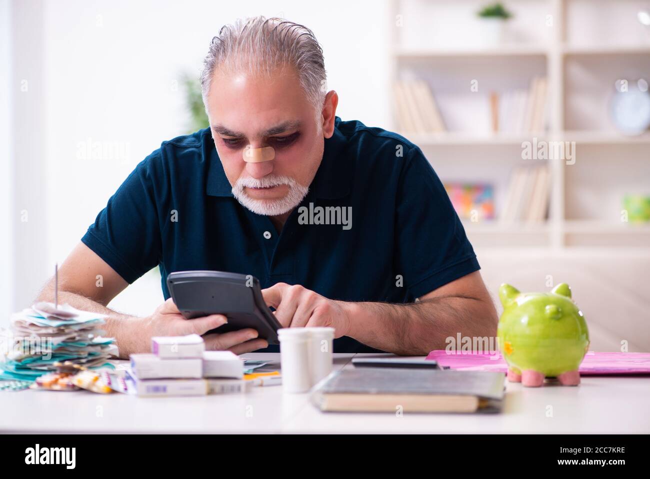 Old man in budget planning concept Stock Photo - Alamy