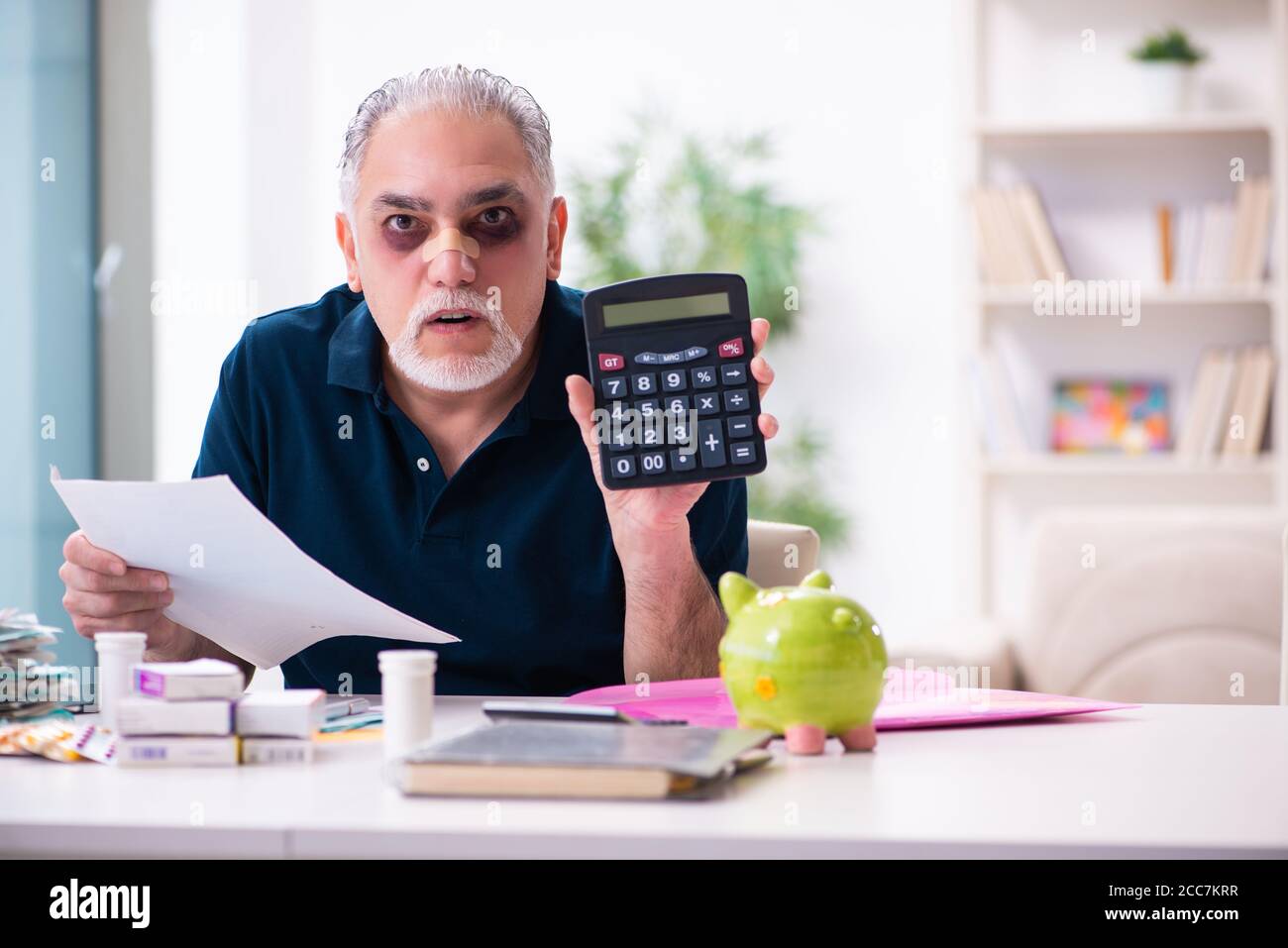 Old man in budget planning concept Stock Photo - Alamy