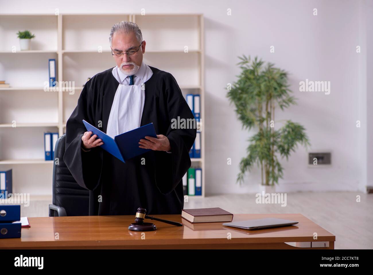 Old judge working in courthouse Stock Photo - Alamy