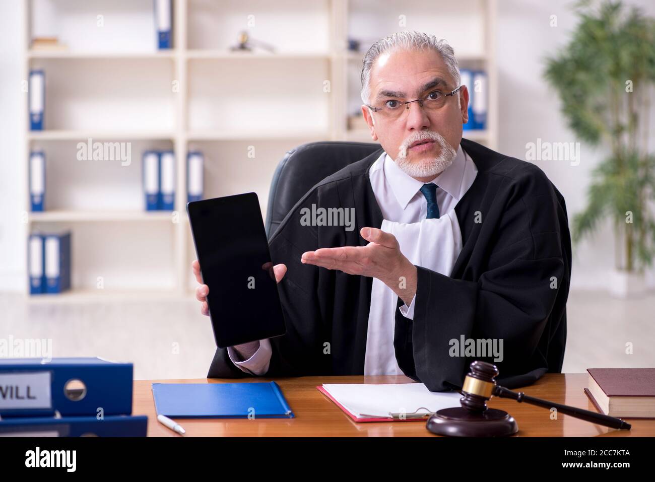 Old judge working in courthouse Stock Photo - Alamy