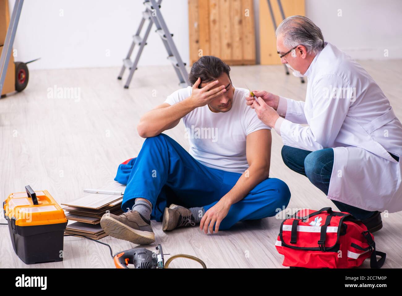 Experienced paramedic helping worker bitten by snake Stock Photo - Alamy