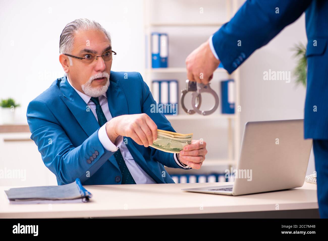 Male employee and cop in police investigation Stock Photo - Alamy