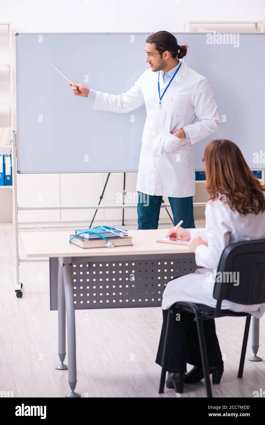 Young teacher doctor and female student in the classroom Stock Photo ...