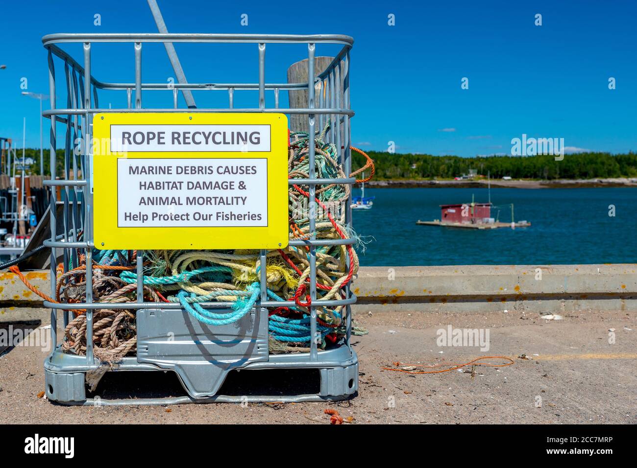 A bin labeled ROPE RECYCLING on a wharf. The bin is for marine rope and ...