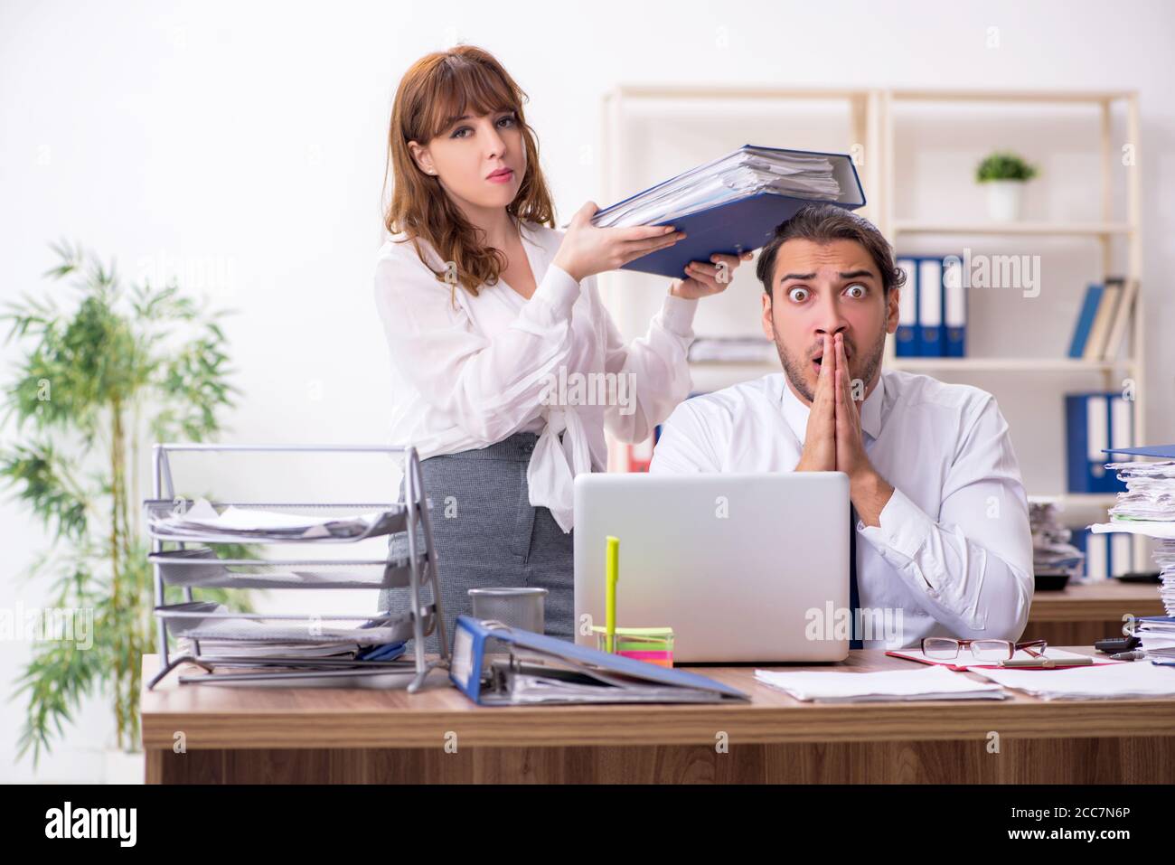 Two employees working in the office environment Stock Photo - Alamy