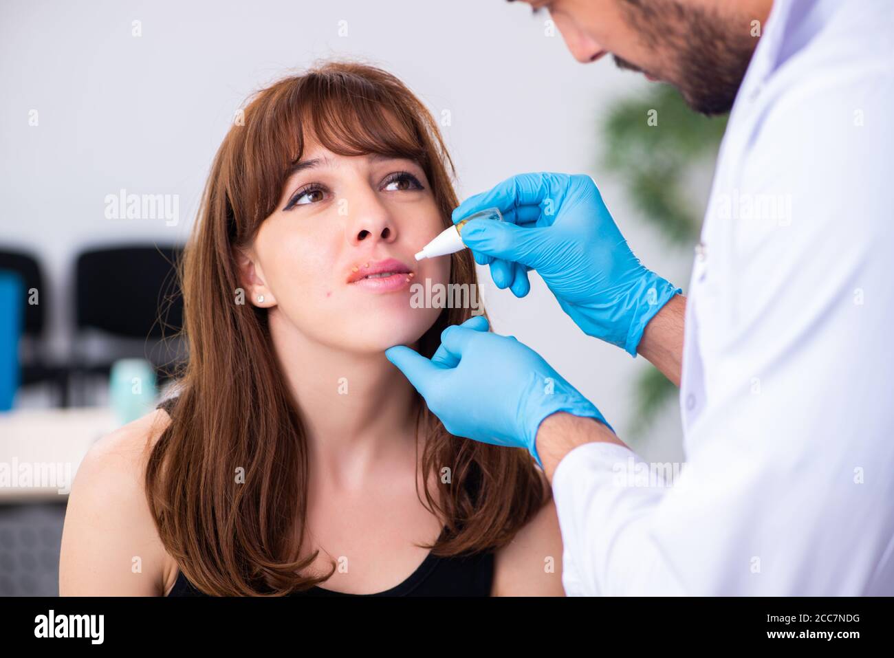 Young woman visiting doctor dermatologist Stock Photo - Alamy
