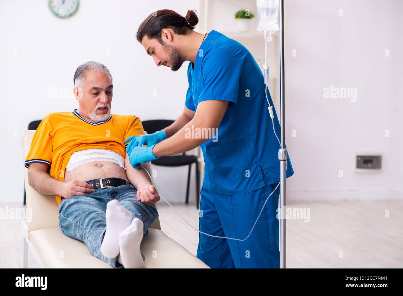 Old man visiting male doctor Stock Photo - Alamy