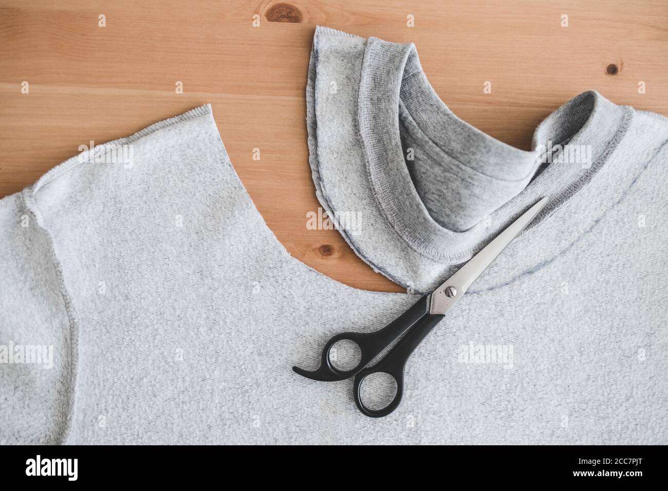 fashion diy and upcycling old clothes concept, sweatshirt with scissors ...