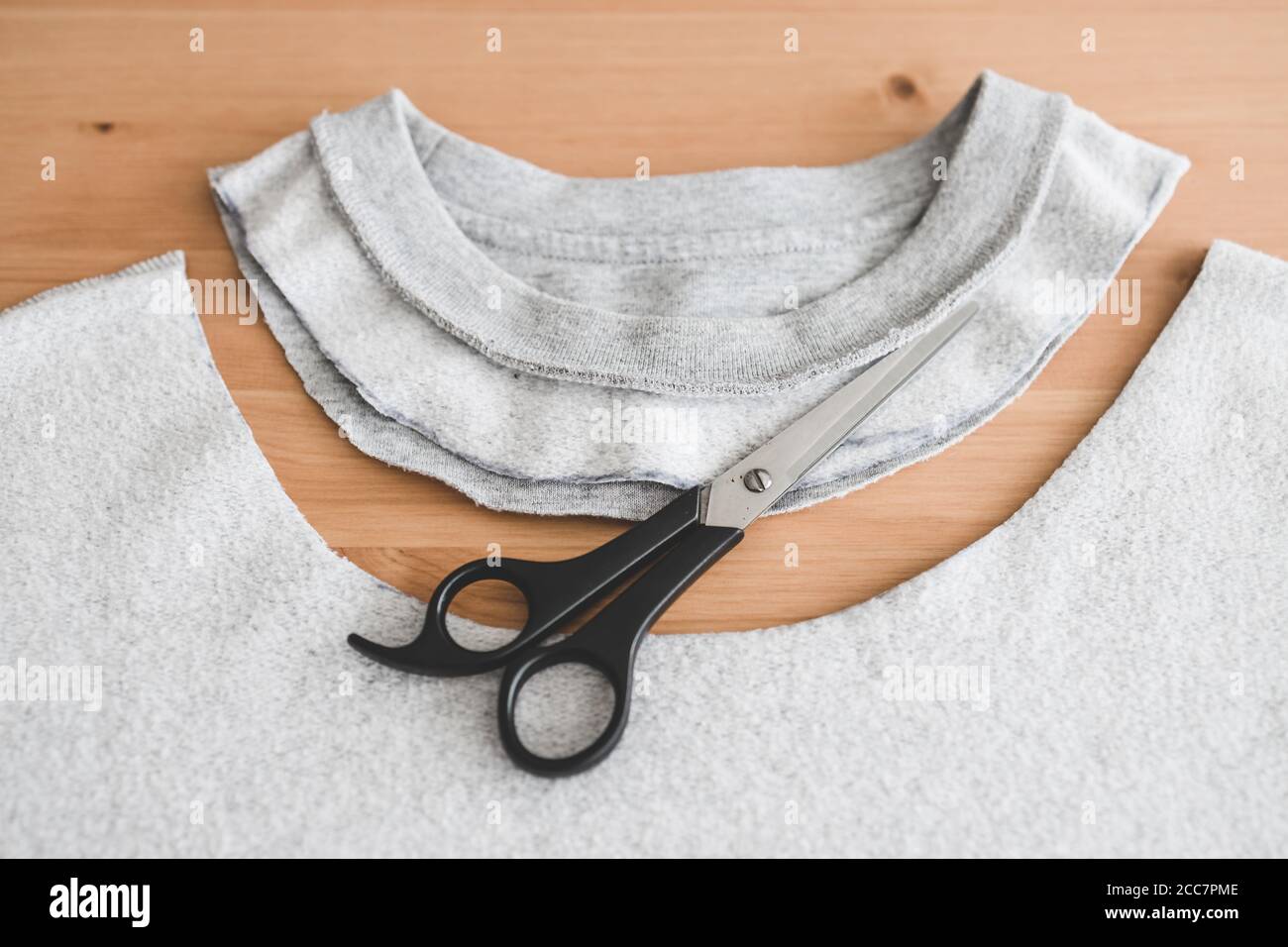 fashion diy and upcycling old clothes concept, sweatshirt with scissors ...